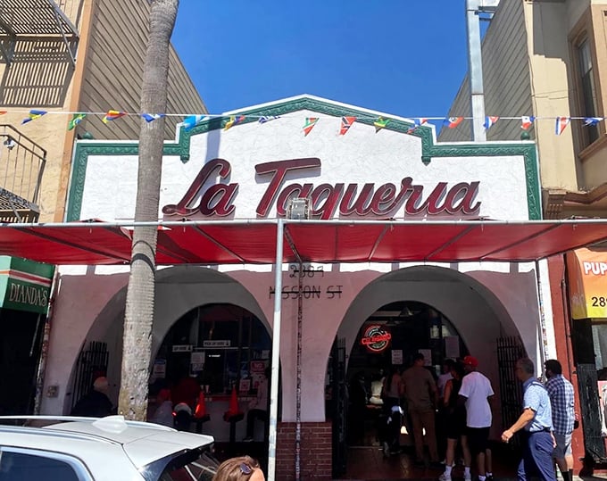La Taqueria's iconic storefront beckons hungry taco lovers with its vintage sign and bustling entrance. The Mission District institution that launched a thousand food pilgrimages.