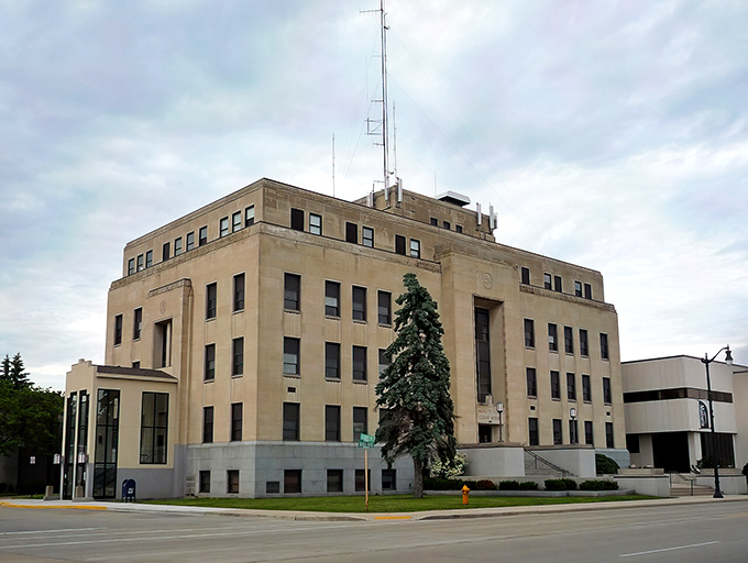 The stately Marinette County Courthouse stands as a testament to small-town governance, where your property tax bill might actually be manageable on Social Security.