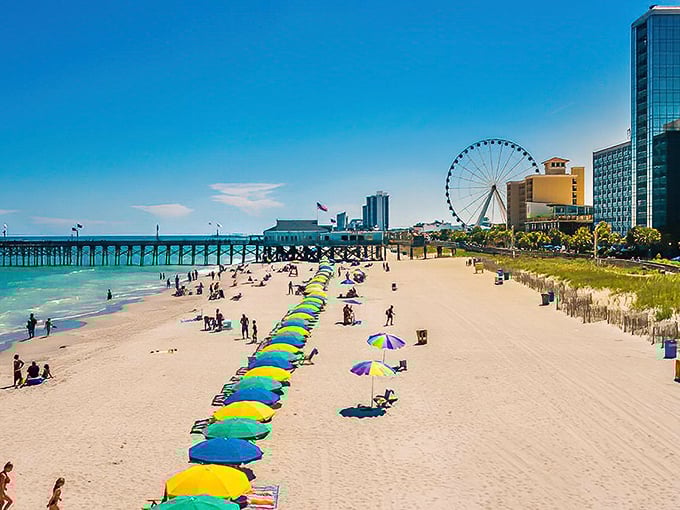 Paradise by the yard! Colorful umbrellas dot the shoreline like sprinkles on the world's longest beach sundae.