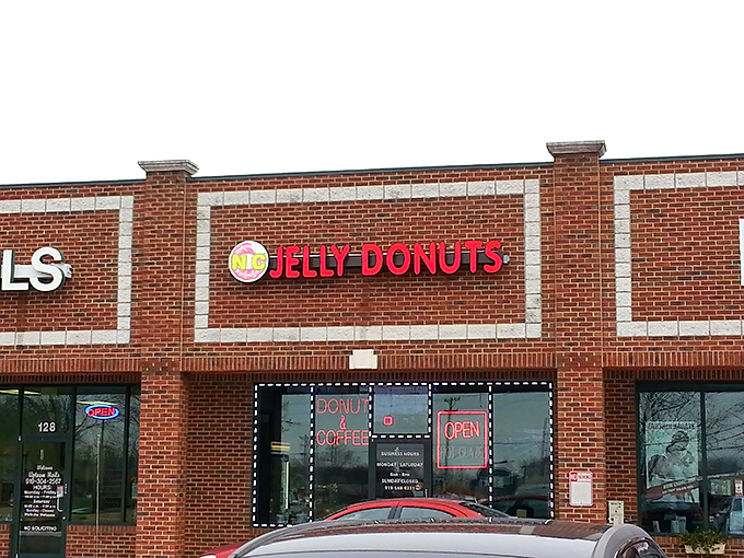 The bright Jelly Donuts sign beckons like a lighthouse for the sweet-toothed. This brick storefront in Mebane promises sugary salvation for donut pilgrims.