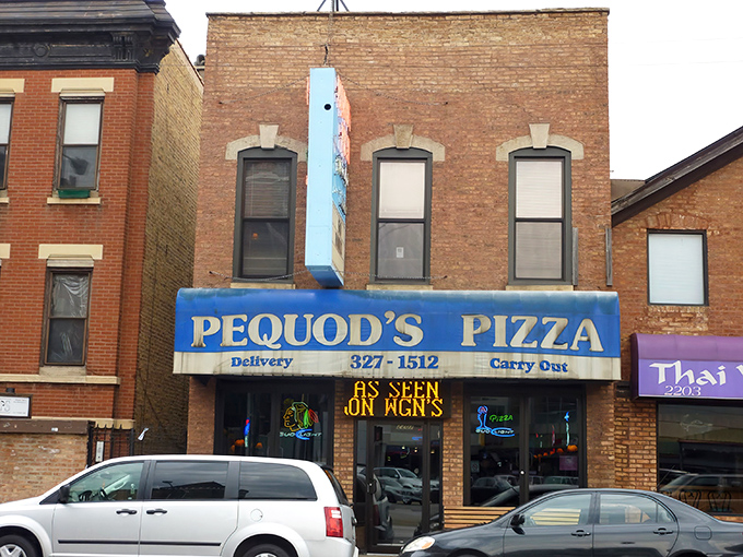 The iconic blue awning of Pequod's Pizza beckons like a lighthouse for hungry sailors on Chicago's pizza seas.