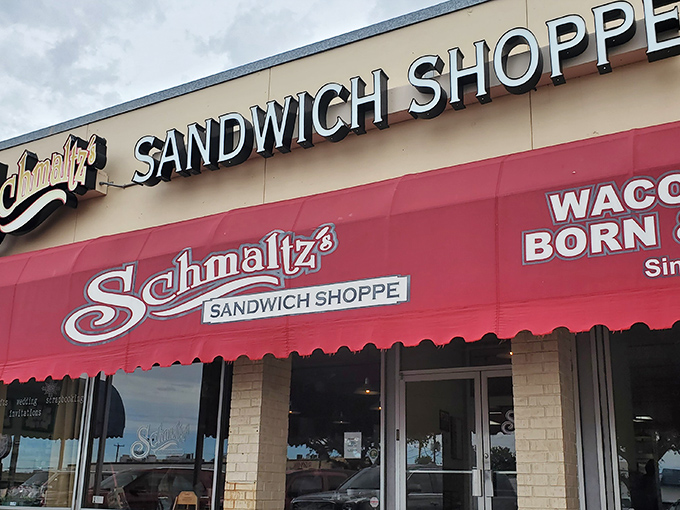 Schmaltz's iconic red awning beckons sandwich lovers like a lighthouse for the hungry. A Waco institution where bread dreams come true.