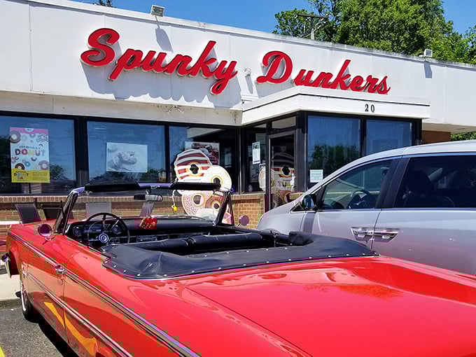 The iconic red Spunky Dunkers sign promises sweet treasures inside. That vintage convertible knows exactly where to park for morning delights!