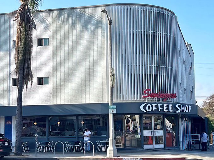 Swingers Diner's sleek silver exterior gleams like a time machine to the golden age of diners. That curved corner entrance practically whispers "come in for pancakes."