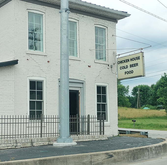 The Chicken House's white brick building stands like a humble temple to fried chicken. That simple sign tells you everything you need to know: good food awaits inside.