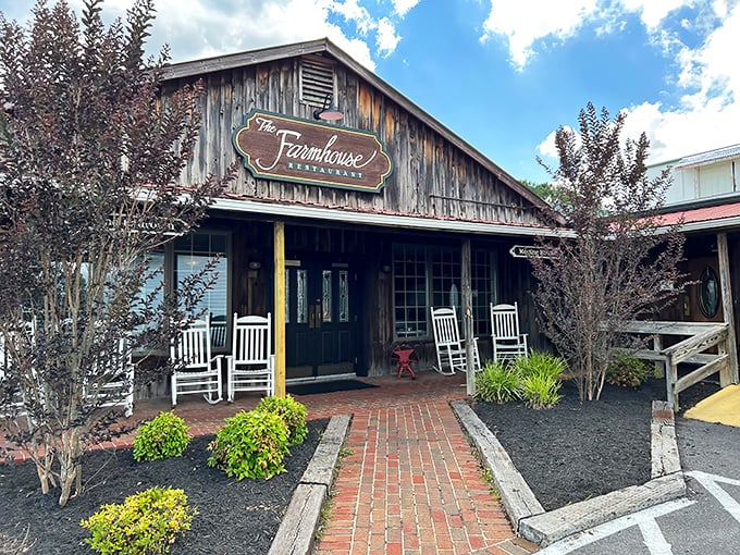 The Farmhouse Restaurant's weathered wooden exterior promises authentic country cooking. Those rocking chairs aren't just for show&mdash;they're for savoring the anticipation.