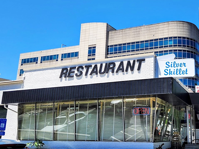The Silver Skillet's iconic storefront promises a time-traveling breakfast experience. That neon "OPEN" sign has welcomed hungry Atlantans for generations.