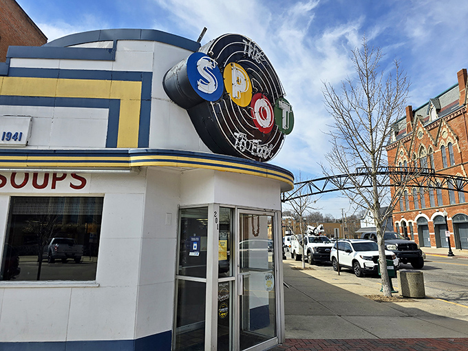The Spot To Eat's iconic neon sign glows like a beacon from 1941, promising comfort food that transcends time.
