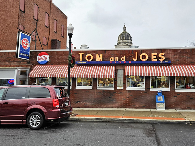 Tom & Joe's iconic storefront beckons with its red-and-white awnings &ndash; like a time machine disguised as a diner.