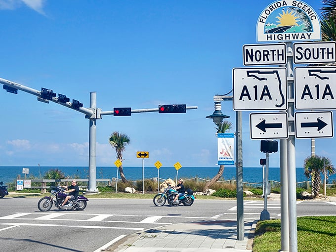 The iconic A1A sign stands sentinel where ocean meets asphalt, promising adventures that smell like sunscreen and freedom.