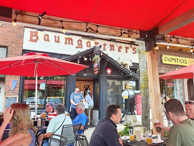 Red umbrellas and cold beer await at Baumgartner's outdoor seating. The perfect spot to brave their legendary limburger sandwich!