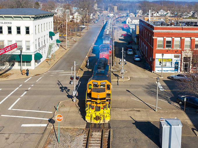 A yellow train chugs through downtown Coshocton, splitting the charming business district like a scene from a Rockwell painting.