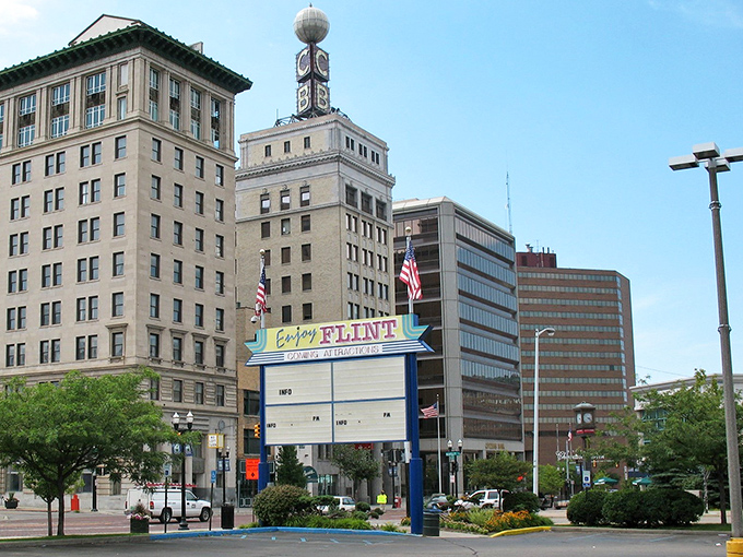 The "Enjoy Flint" sign stands tall among classic buildings, a beacon of civic pride in this resilient Michigan city.
