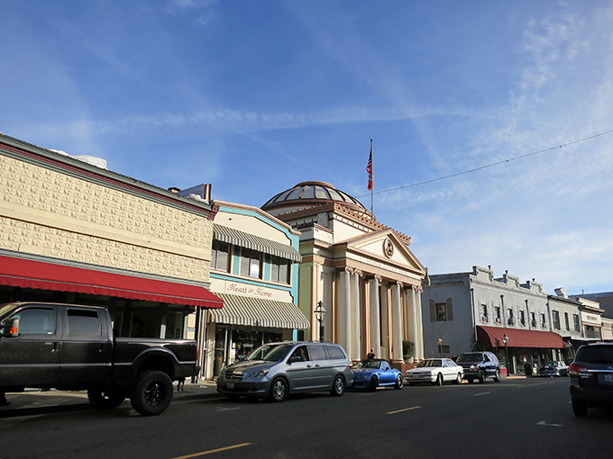 Historic Grass Valley's colorful storefronts stand like a Gold Rush time capsule, where American flags flutter and small-town charm never went out of style.