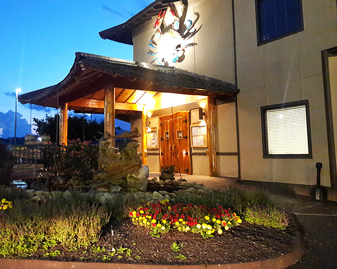 As evening falls, Harpoon Harry's wooden entrance and glowing crab create the perfect backdrop for the seafood feast that awaits inside.