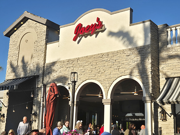 Joey's iconic red sign glows like a lighthouse for the pizza-starved. The kind of place where locals line up before tourists discover it.