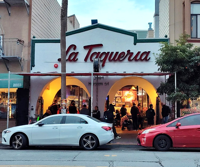 When the sun sets, La Taqueria glows like a taco lighthouse guiding hungry souls to carnitas paradise. Worth every minute in that legendary line!