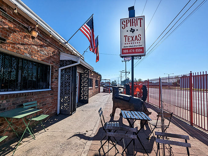 Old Glory waves proudly over this brick BBQ fortress, where smoke signals announce brisket that would make a Texan weep with joy.