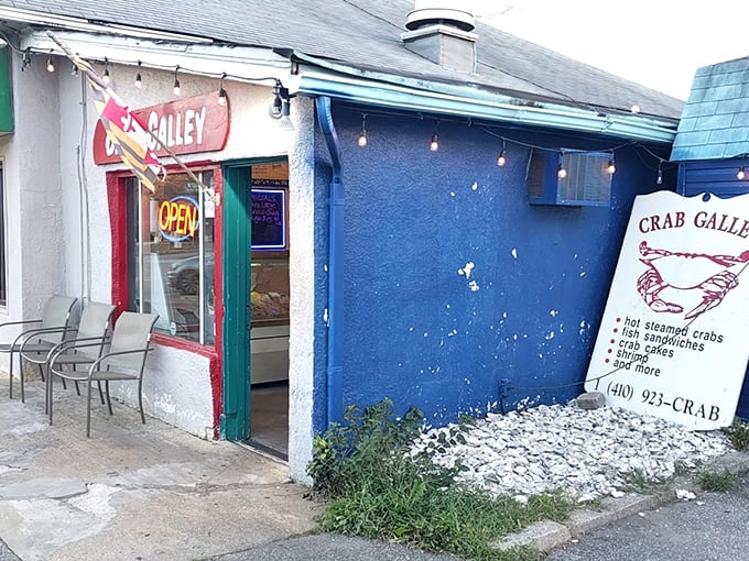 The Crab Galley: Blue walls, string lights, and a neon "OPEN" sign &ndash; the universal language for "get in here and eat something amazing."