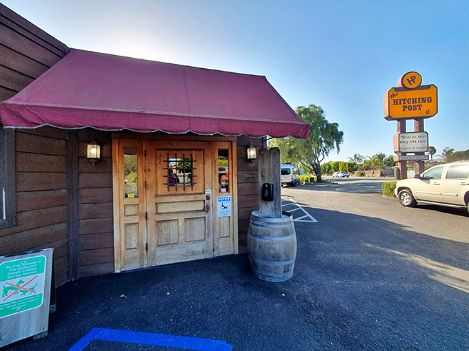 This unassuming roadside spot hides oak-fired magic within. That yellow sign has been guiding hungry travelers to steak nirvana for decades.