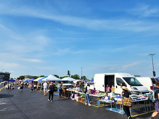 Blue skies and better deals. Shoppers navigate this asphalt bazaar like seasoned explorers, each table a new continent of possibilities.