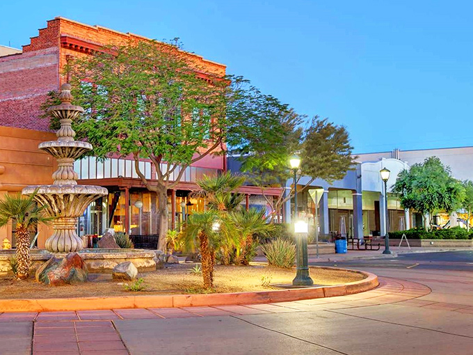 A peaceful fountain anchors Yuma's historic district, where desert palms and brick buildings create an oasis of small-town tranquility.