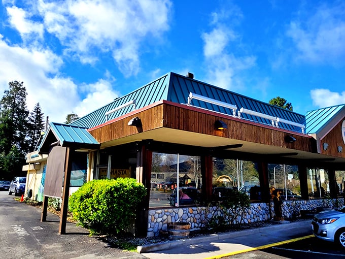 This isn't just any roadside diner&mdash;it's where locals gather for hearty breakfasts before mountain adventures. Blue roof, stone foundation, comfort food paradise.