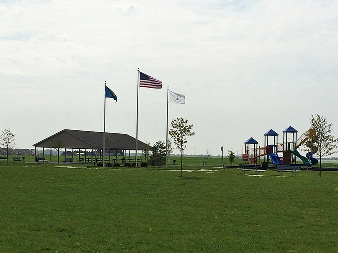 At Charles E. Price Memorial Park, three flags wave over open spaces where memories are made. The playground beckons both grandkids and the young-at-heart.