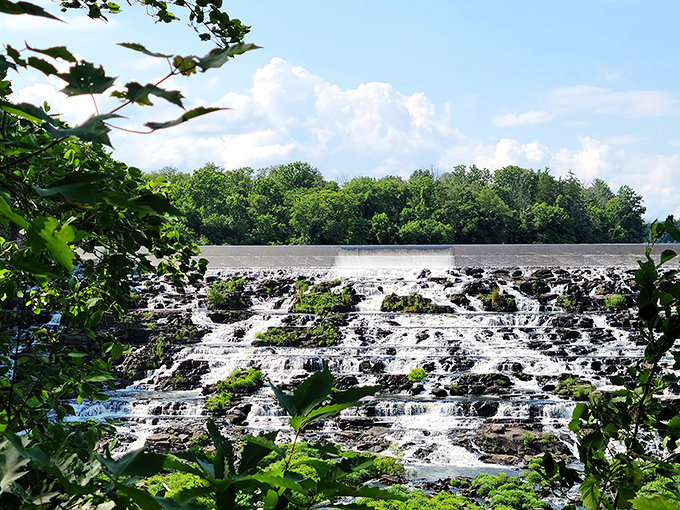 Nature's staircase in action. The dam spillway creates a mesmerizing cascade that's equal parts engineering marvel and accidental water feature artwork.