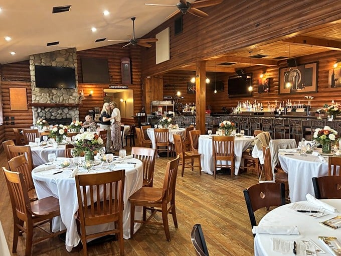 Rustic elegance meets Michigan comfort in this dining room where white tablecloths and wooden beams create the perfect steakhouse symphony.