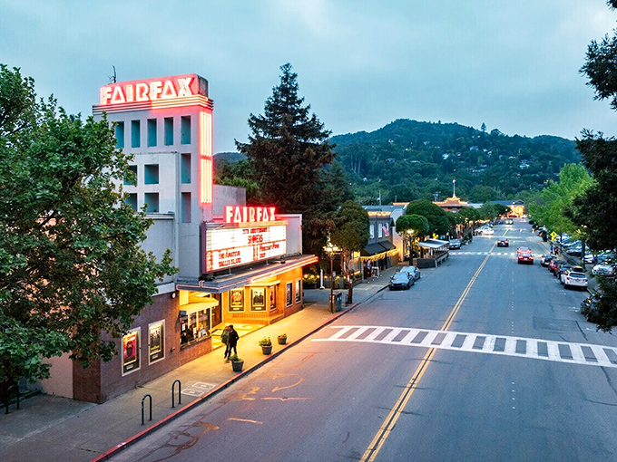 The neon glow of Fairfax Theater beckons at twilight, a reminder that small-town charm doesn't disappear after dark.