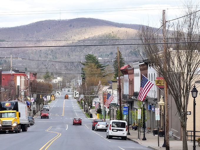 American flags flutter along Bridge Street as the mountains provide a dramatic backdrop. Norman Rockwell couldn't have painted a more quintessential American main street.