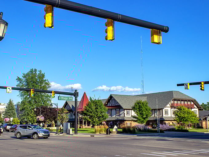 Blue skies frame Gaylord's distinctive Alpine village aesthetic, where steep-roofed chalets and colorful landscaping create a postcard-perfect downtown intersection.