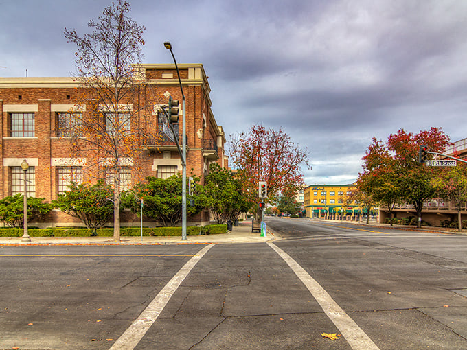 Downtown Bakersfield's historic brick buildings stand as testaments to the city's resilience, where autumn trees add splashes of color to streets unburdened by tourist crowds.