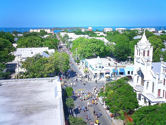 Duval Street from above reveals the beating heart of Key West, where historic churches keep watch over the cheerful chaos of paradise.