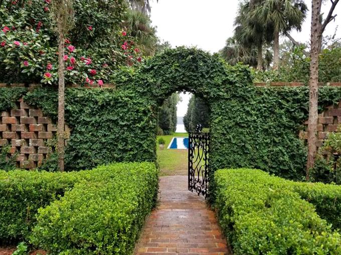 Secret garden vibes so strong you'll check for Mr. Tumnus. This ivy-covered archway promises magic beyond the wrought iron gate.