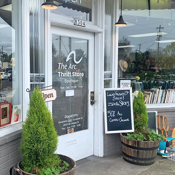 Flanked by cheerful greenery, the entrance promises adventure with its handwritten sales board&mdash;25% off shoes and 50% off coats? I'm already reaching for my wallet!