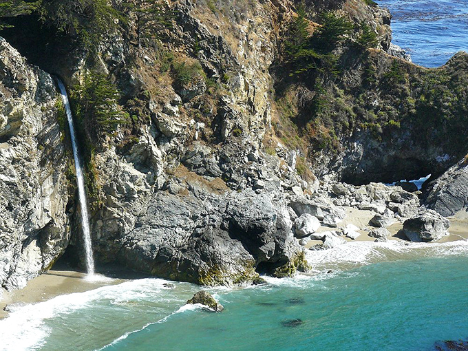 McWay Falls performs its endless 80-foot plunge to the beach below, a waterfall so perfectly situated it looks like Mother Nature hired a landscape architect.