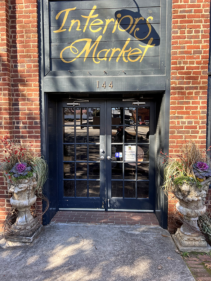 Elegant stone planters flank the entrance to Interiors Market, like sentinels guarding a portal to design inspiration and vintage treasures.