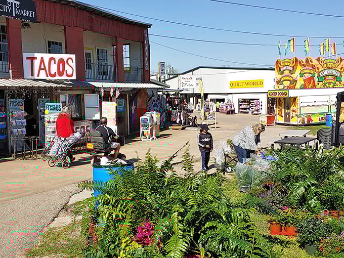 Where tacos meet treasures. The red building houses quick bites while shoppers navigate the labyrinth of stalls offering everything from quilts to curiosities.