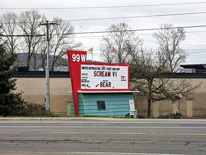 The classic red marquee stands as a cheerful sentinel on Highway 99W, announcing tonight's features with the same retro charm that's welcomed moviegoers for generations. 