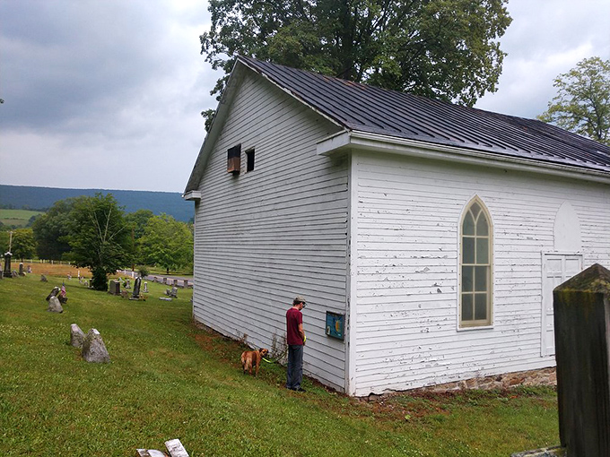 This historic white church stands as a peaceful sentinel to simpler times. The weathered wood and gothic window frame stories of generations past.