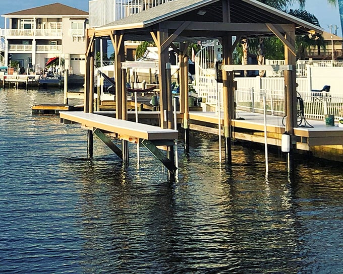 A covered boat dock that says "Florida retirement" more clearly than any brochure ever could. 