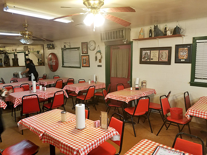 Red-checkered tablecloths and simple chairs create that "grandma's dining room" vibe where calories don't count and conversations flow as freely as the sweet tea.