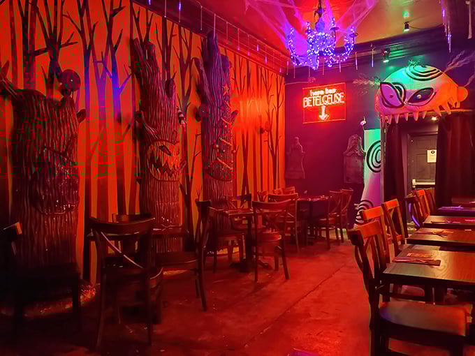 Step into a nightmare you never want to leave—crimson walls, twisted trees, and a chandelier that would make the Addams Family jealous.