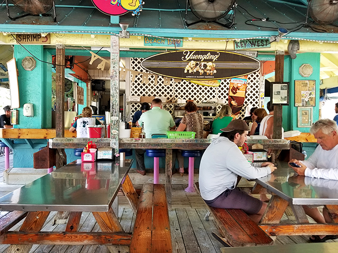 Picnic tables and surfboards create that "friend's beach house" vibe where conversations flow as easily as the drinks.