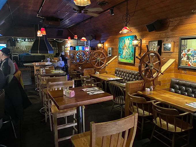 Nautical nostalgia meets cozy comfort in this wood-paneled dining room where ship wheels and fishing artifacts tell tales of the sea.