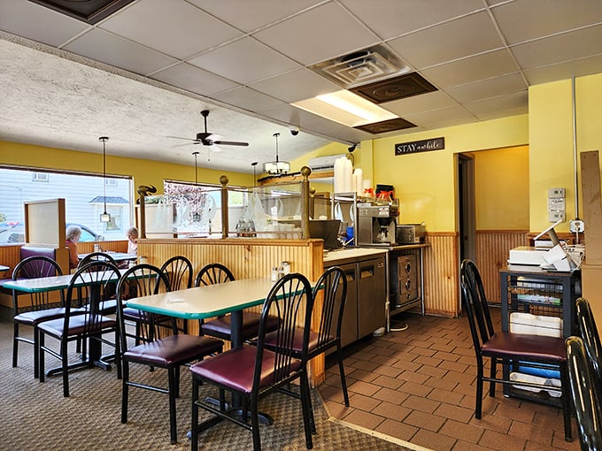 Cheerful yellow walls and classic diner seating create that "where everybody knows your name" vibe, minus the complicated Boston accents.