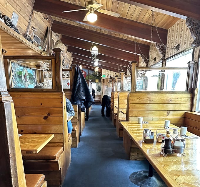 Wooden booths that feel like private dining cabins. These high-backed pine havens have witnessed countless vacation memories and maple syrup spills since day one.