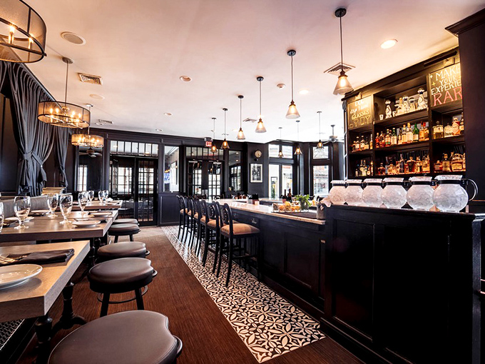 Dark wood, elegant lighting, and a perfectly arranged bar create that rare atmosphere where sophistication meets comfort&mdash;like your favorite blazer.